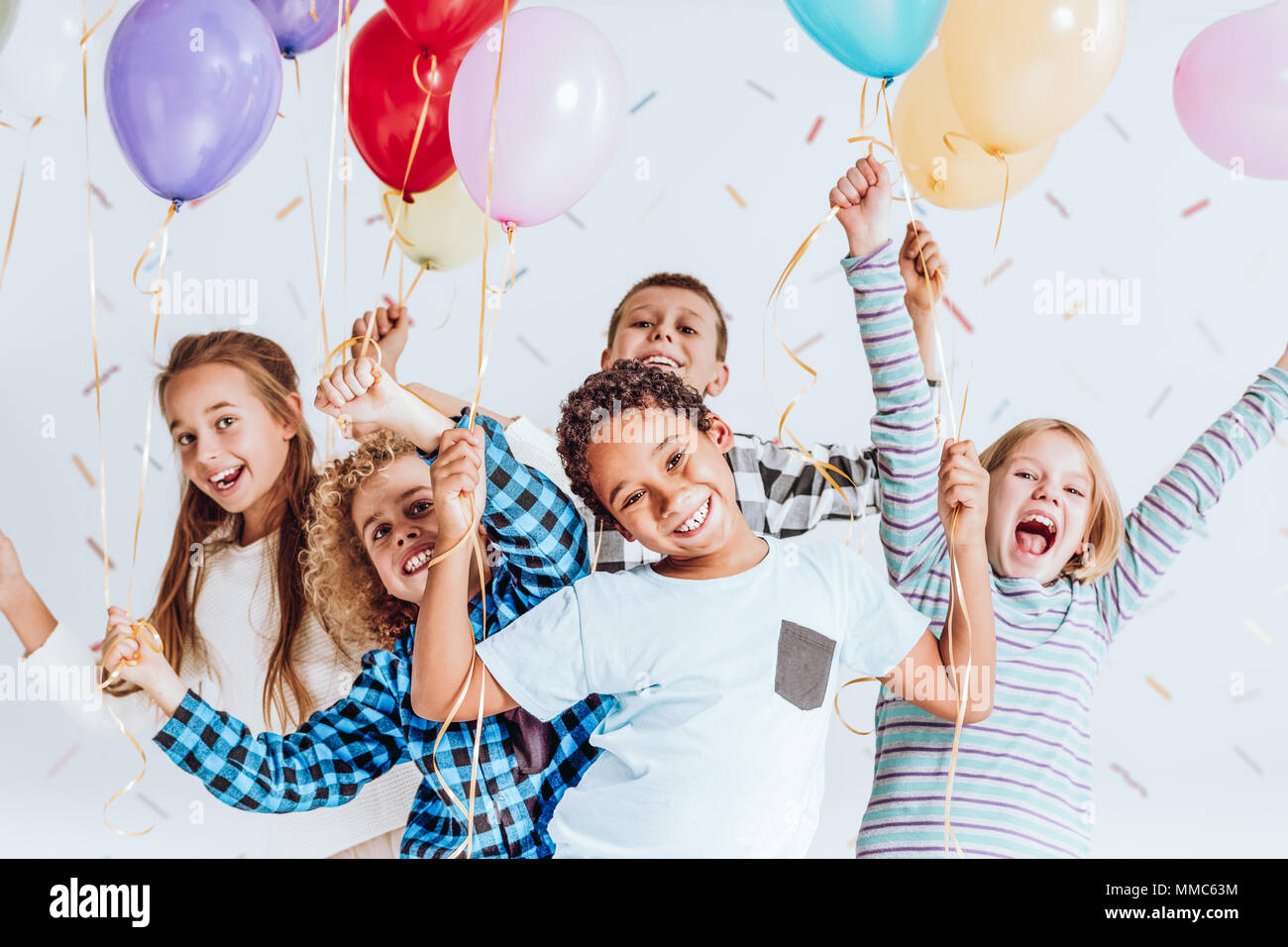 Group of happy kids laughing, having fun and holding balloons Stock ...