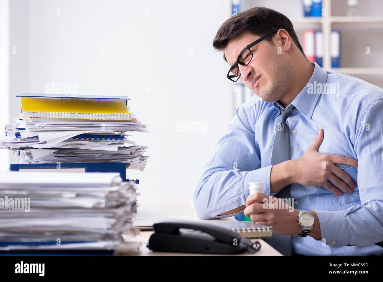 Extremely busy businessman working in office Stock Photo - Alamy
