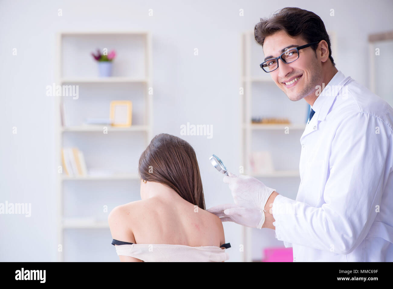 Doctor examining the skin of female patient Stock Photo - Alamy