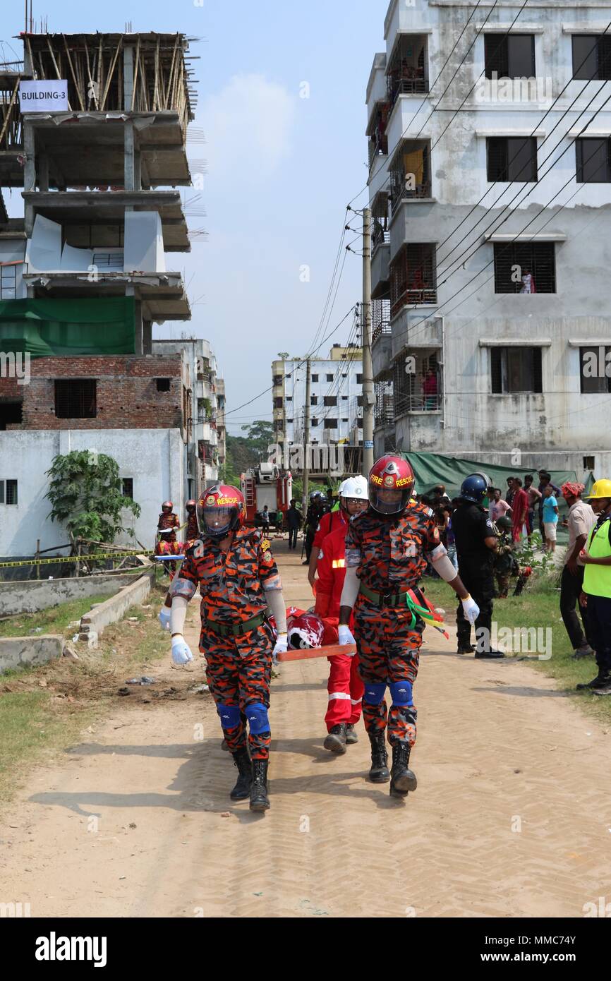 The Bangladesh Fire Service and Civil Defense team, carries a wounded ...
