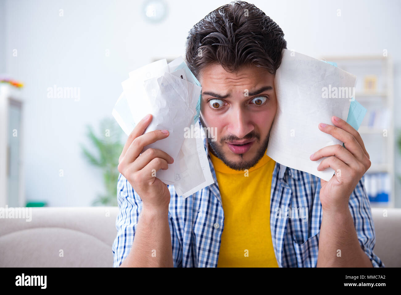Man angry at bills he needs to pay Stock Photo - Alamy