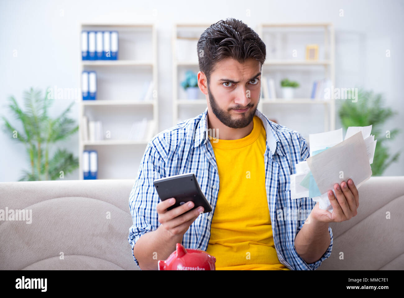 Man angry at bills he needs to pay Stock Photo - Alamy