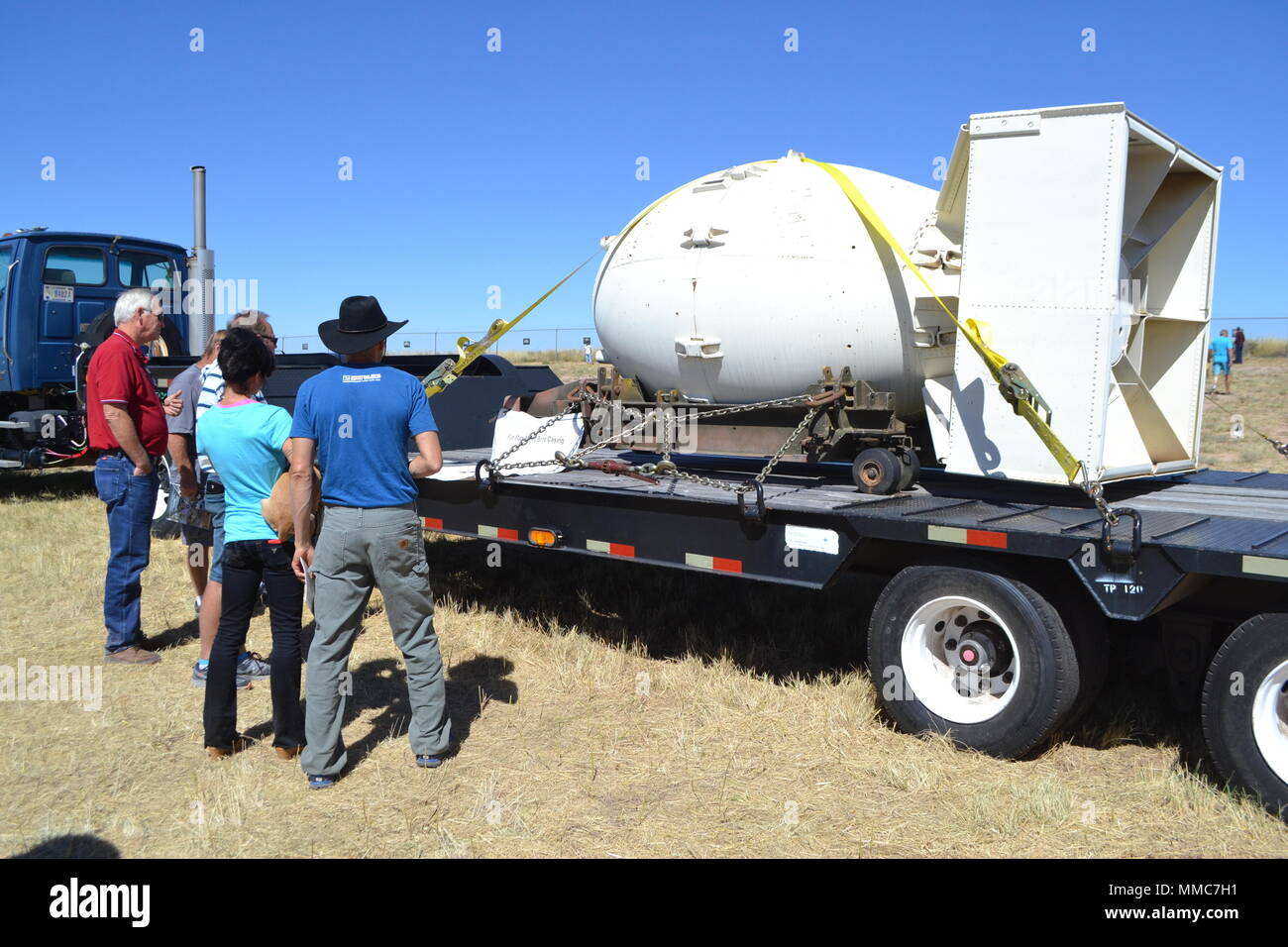 Visitors crowd around a bomb casing nearly identical to the Fatman bomb ...