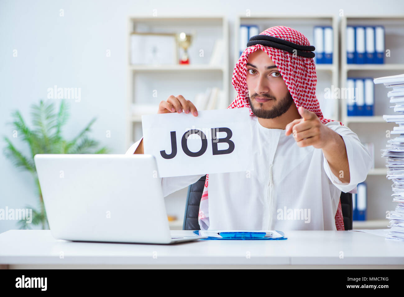 Arab man sitting at desk with message Stock Photo - Alamy