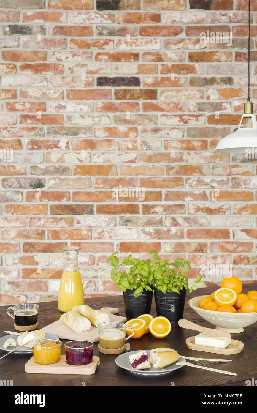 Industrial brick wall and food lying on wood table Stock Photo - Alamy