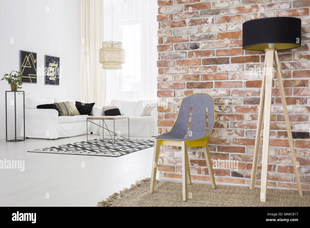 Trendy loft with brick wall and white living room Stock Photo - Alamy