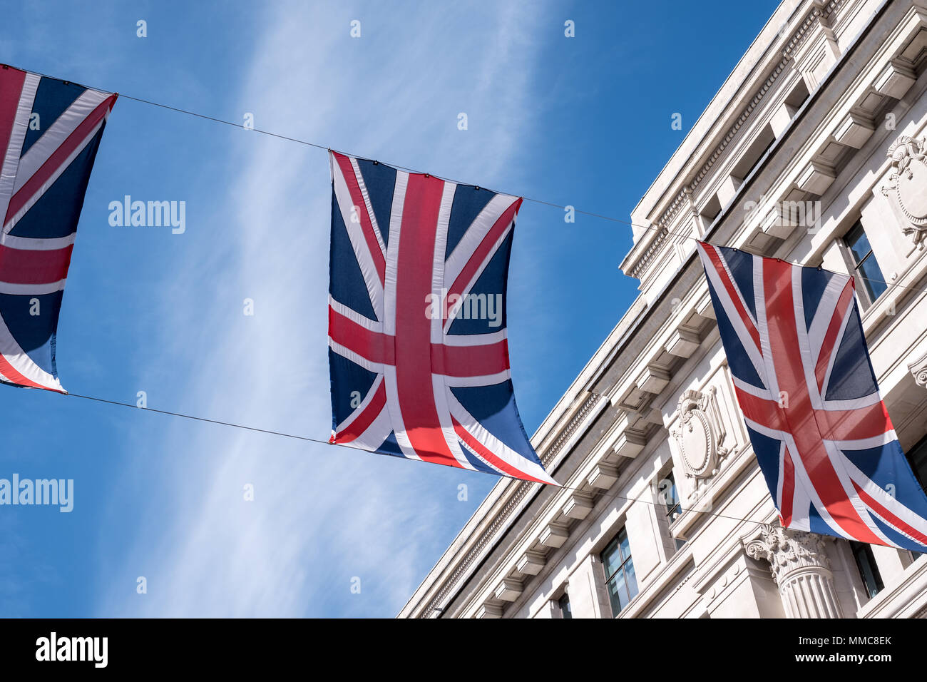 Close up of buildings on Regent Street London with row of British flags ...
