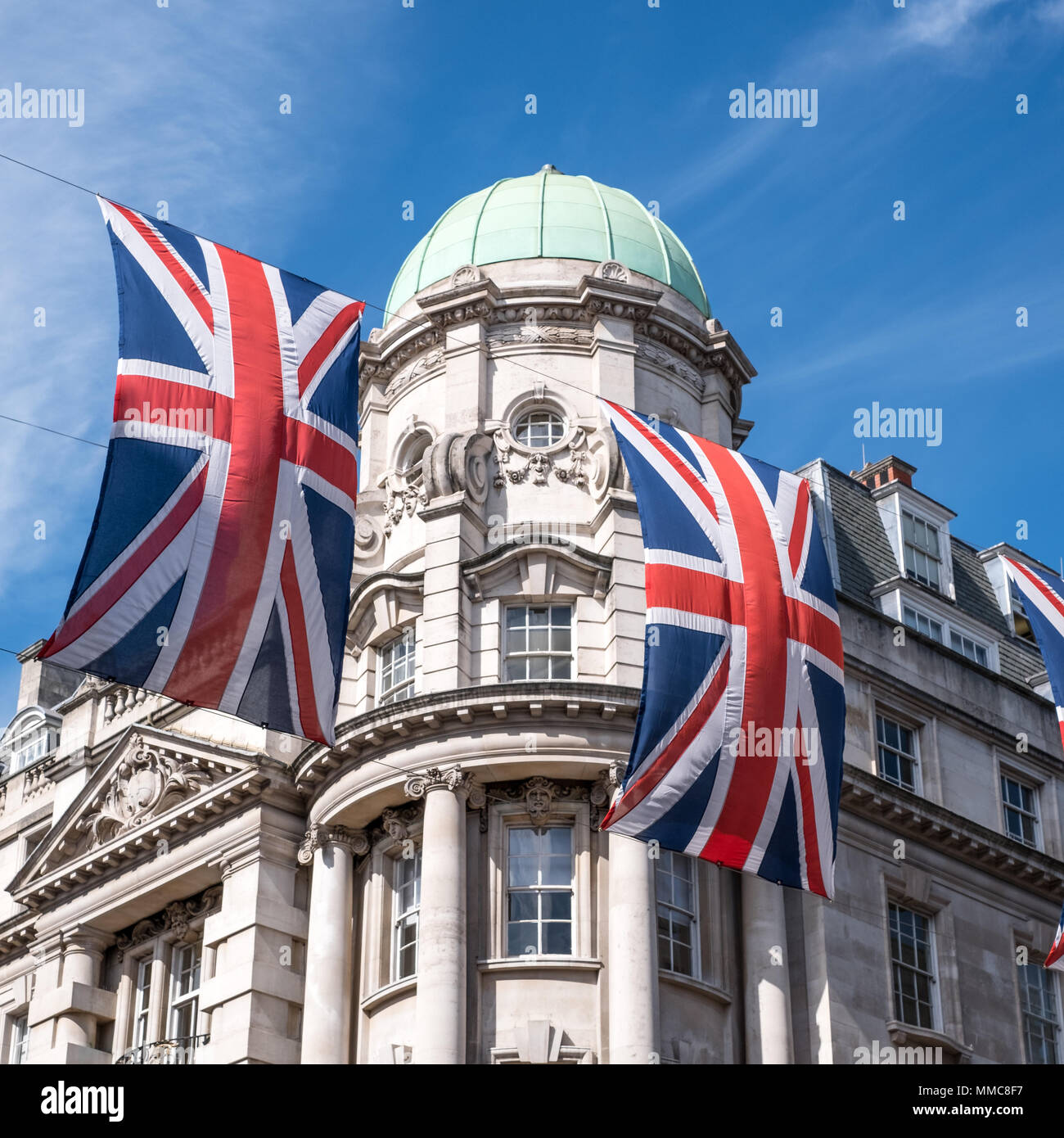 Close up of buildings on Regent Street London with row of British flags ...