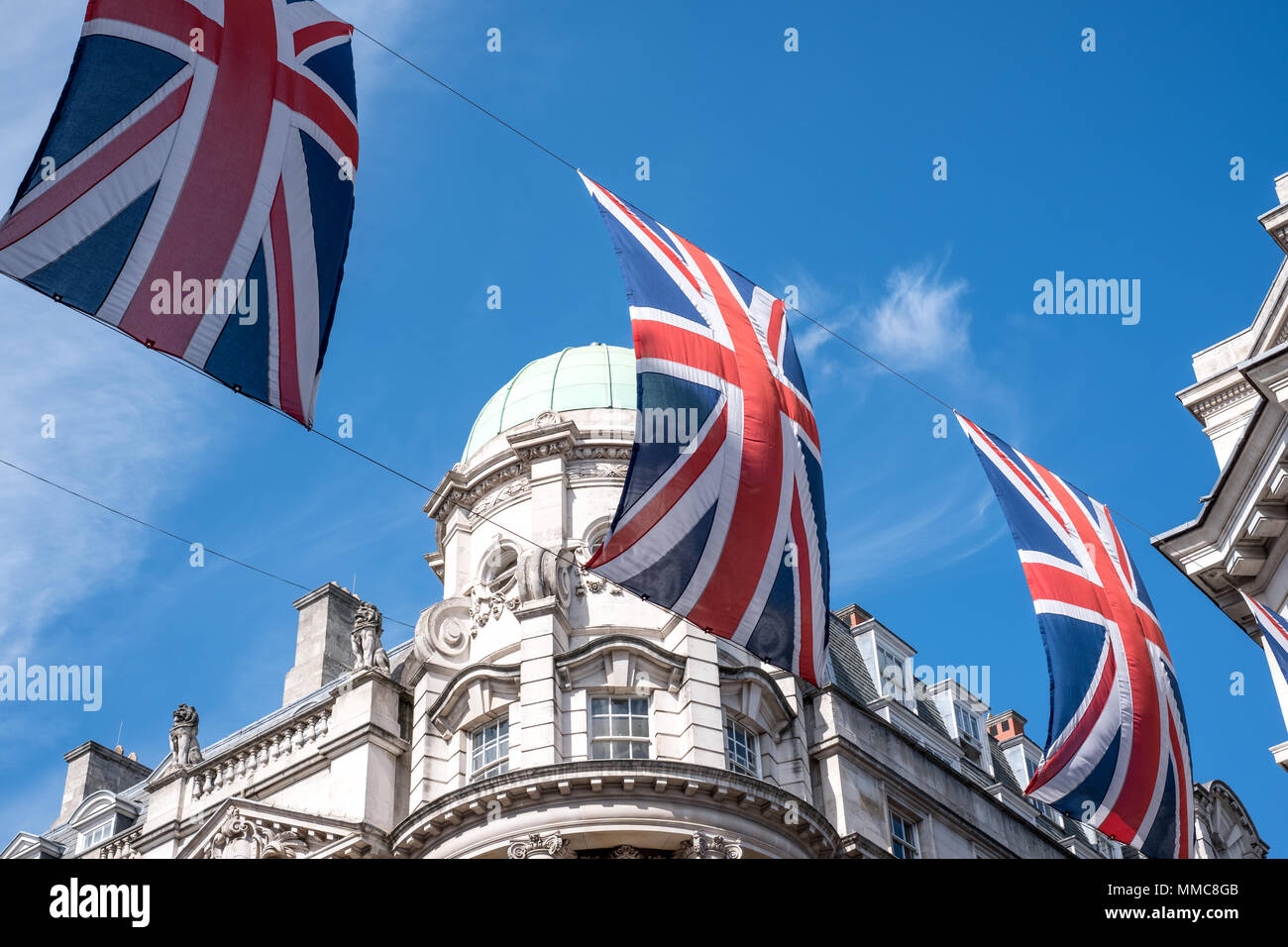 Close up of buildings on Regent Street London with row of British flags ...