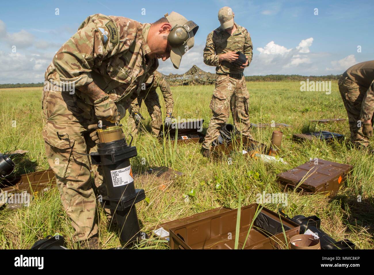 British commando gunners prepare 105mm shells to be fired from an ...