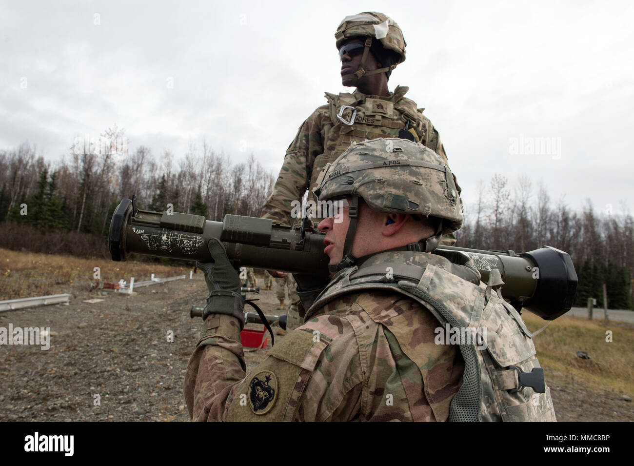 Army Staff Sgt. Kiatwain Andres observes as Staff Sgt. David Riley ...