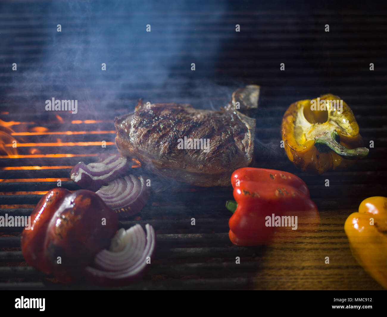delicious grilled meat steak with vegetables on a barbecue Stock Photo ...