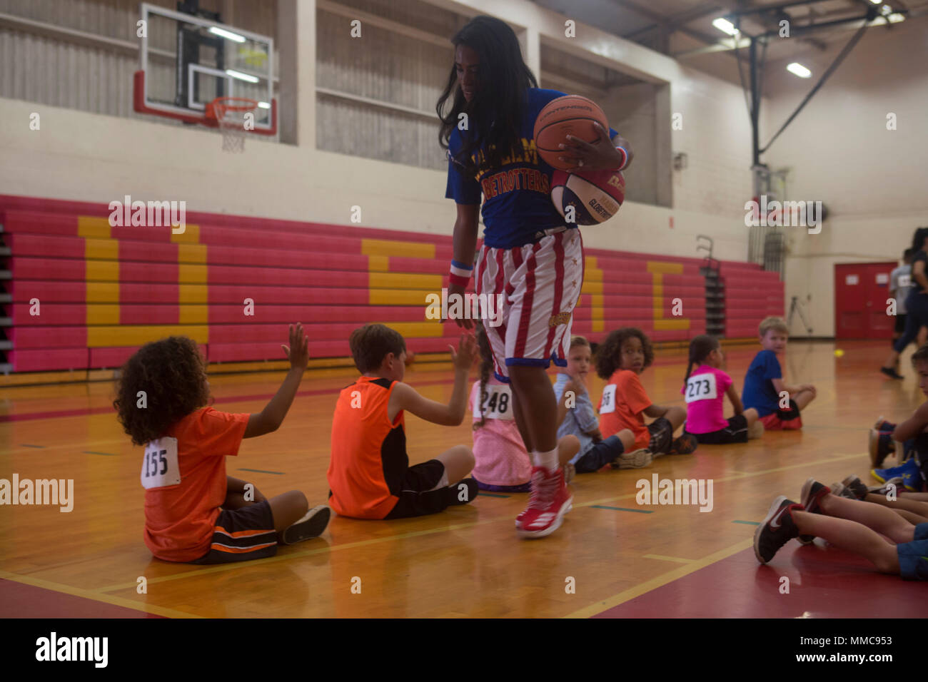 Harlem Globetrotter Fatima “TNT” Lister gives children a high-five at ...