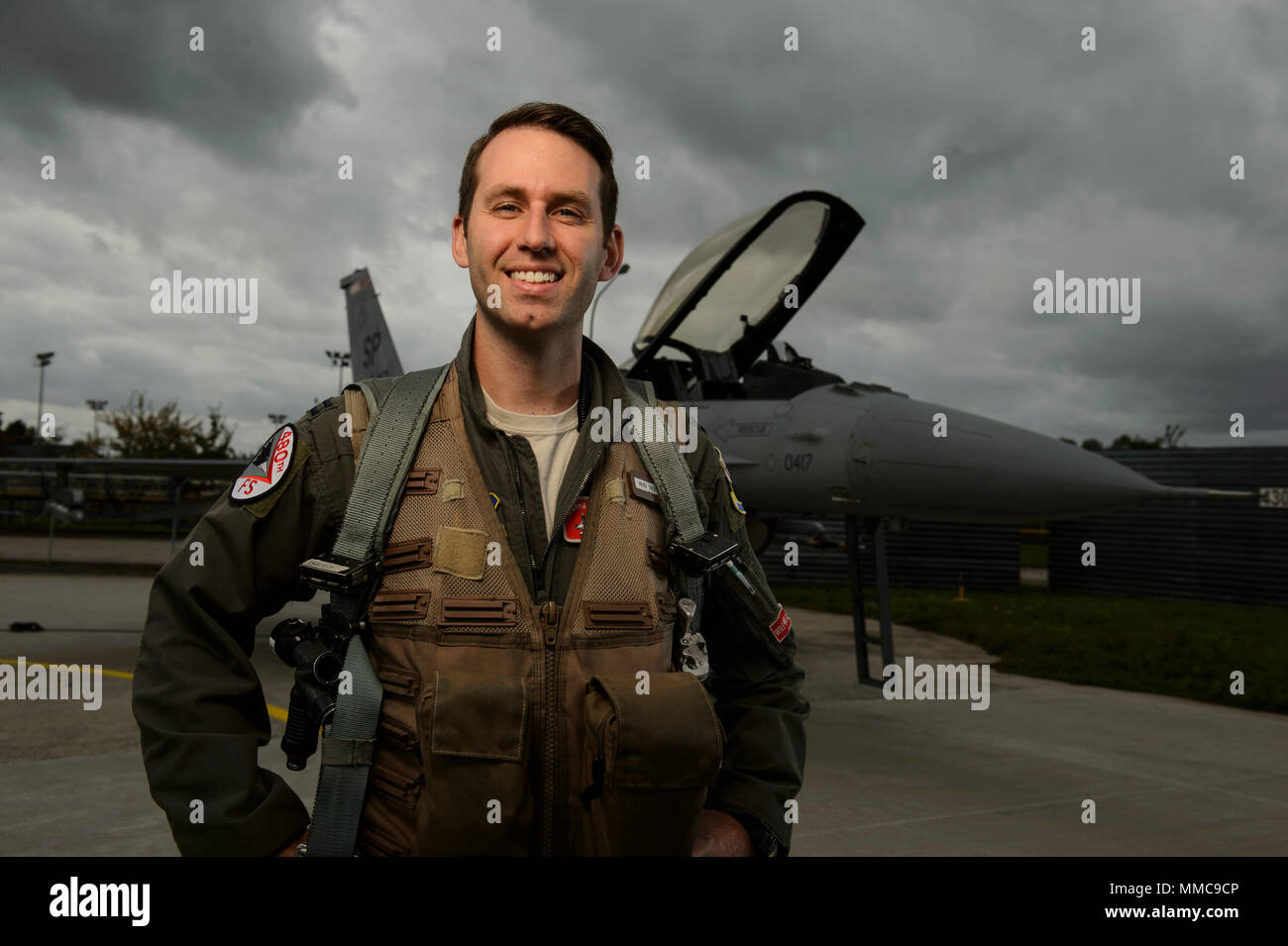Capt. Tyler Brummer, 480th Fighter Squadron F-16 Pilot, stands next to ...