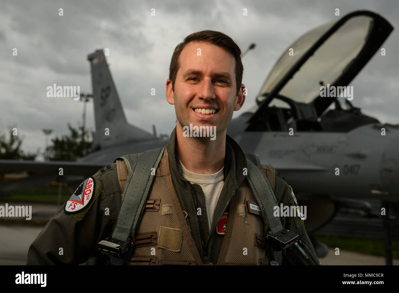 Capt. Tyler Brummer, 480th Fighter Squadron F-16 Pilot, stands next to ...