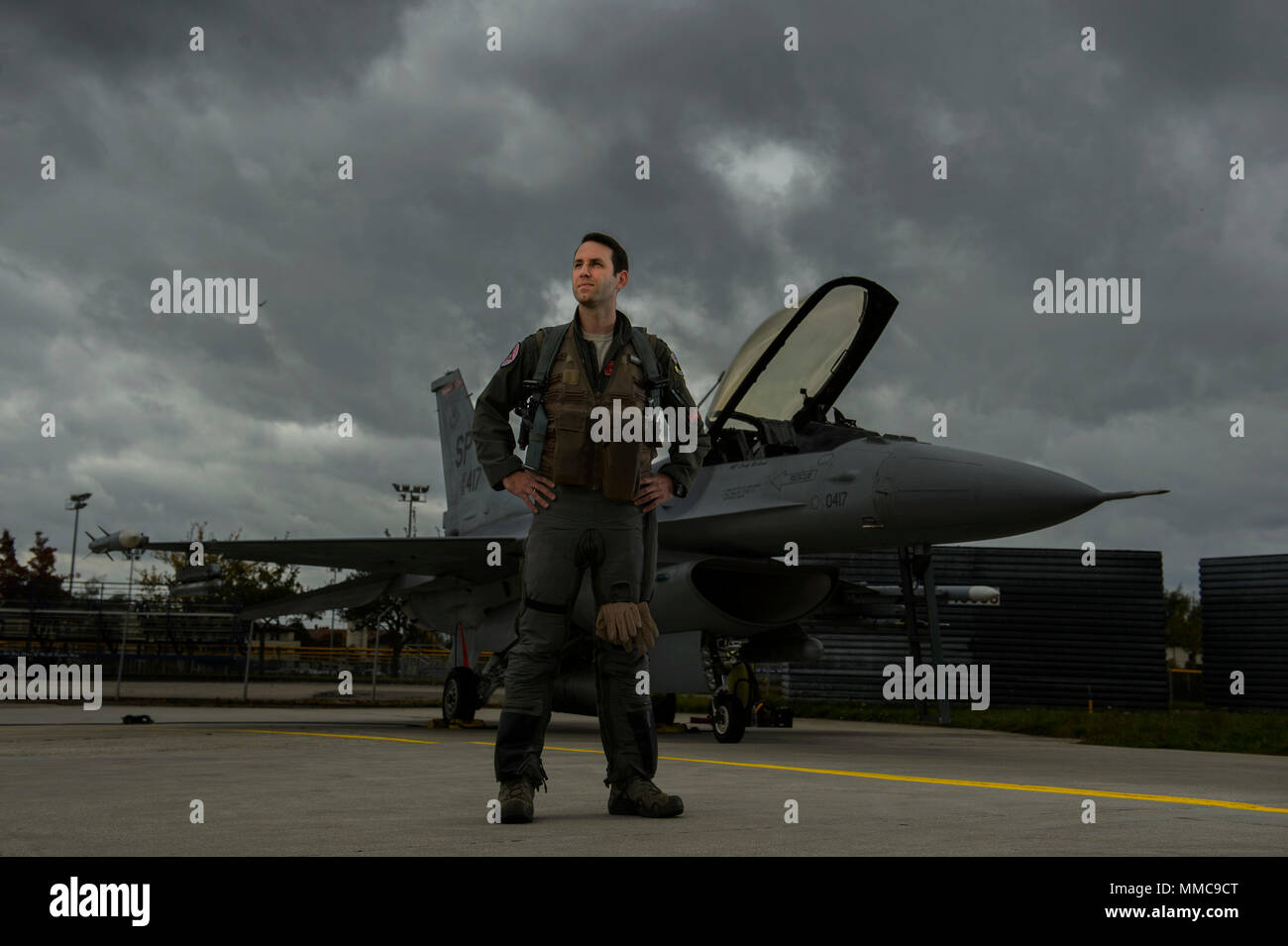Capt. Tyler Brummer, 480th Fighter Squadron F-16 Pilot, stands next to ...