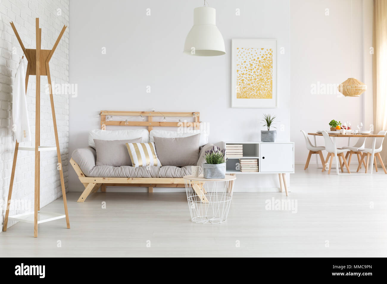 Modern wooden sofa in trendy, white studio Stock Photo - Alamy