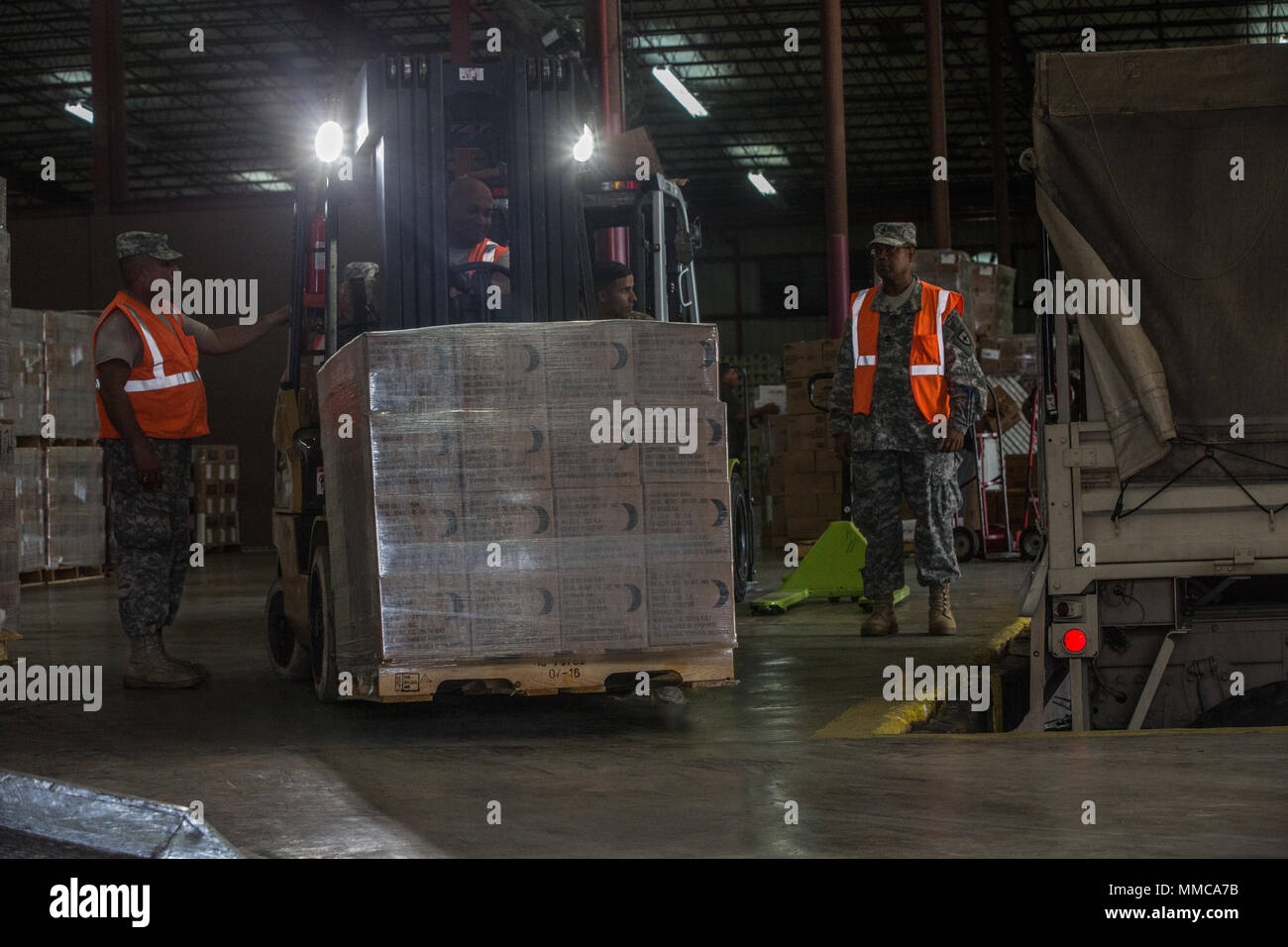 Members of the Puerto Rico State Guard load pallets of Meals Ready to ...