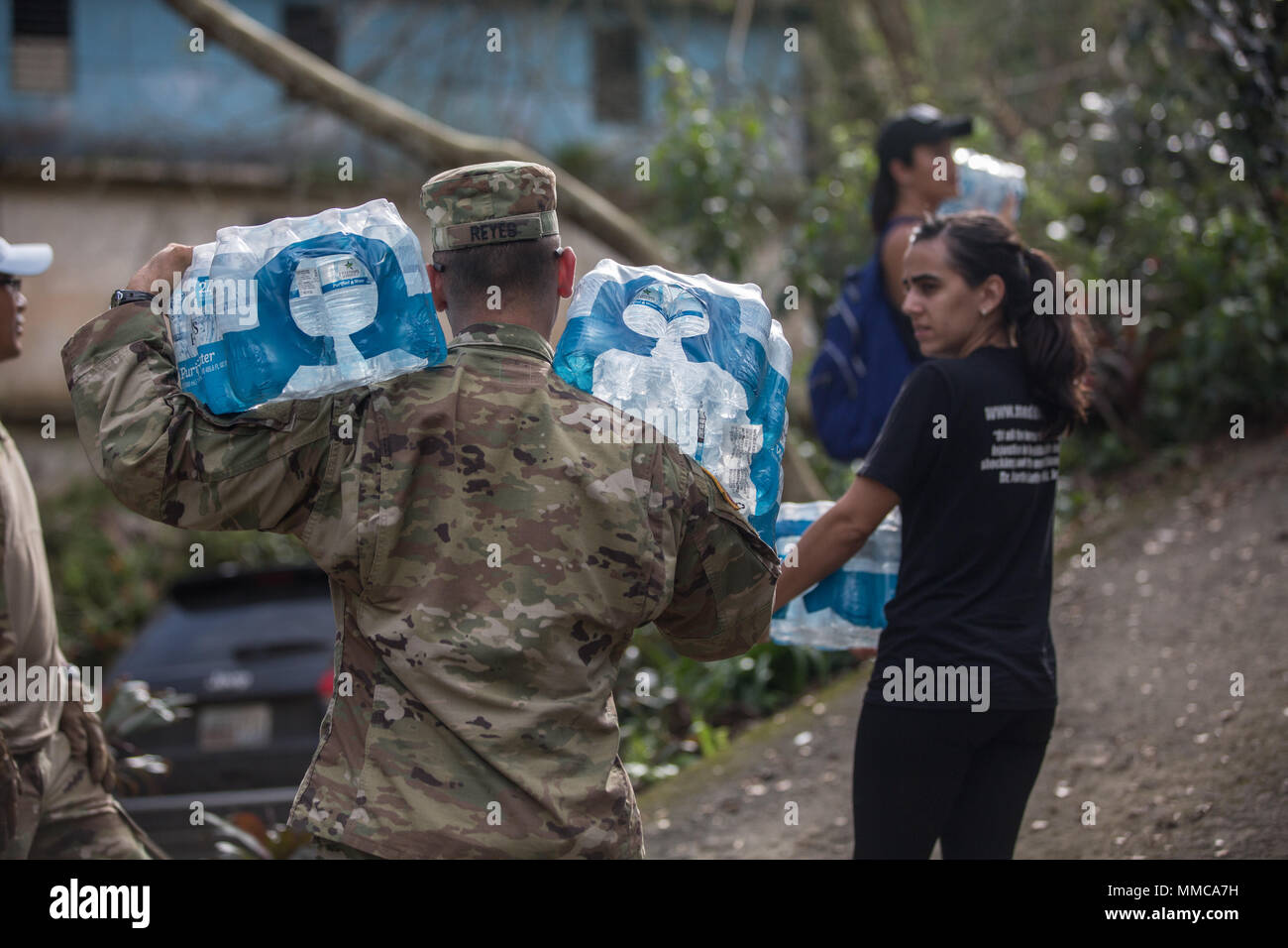 U.S. Soldiers and volunteers of the Love 4 Puerto Rico group carry ...