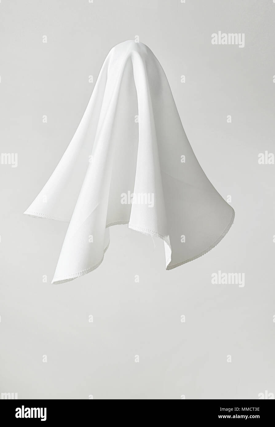 White fabric in shape a ghost on white background Stock Photo - Alamy