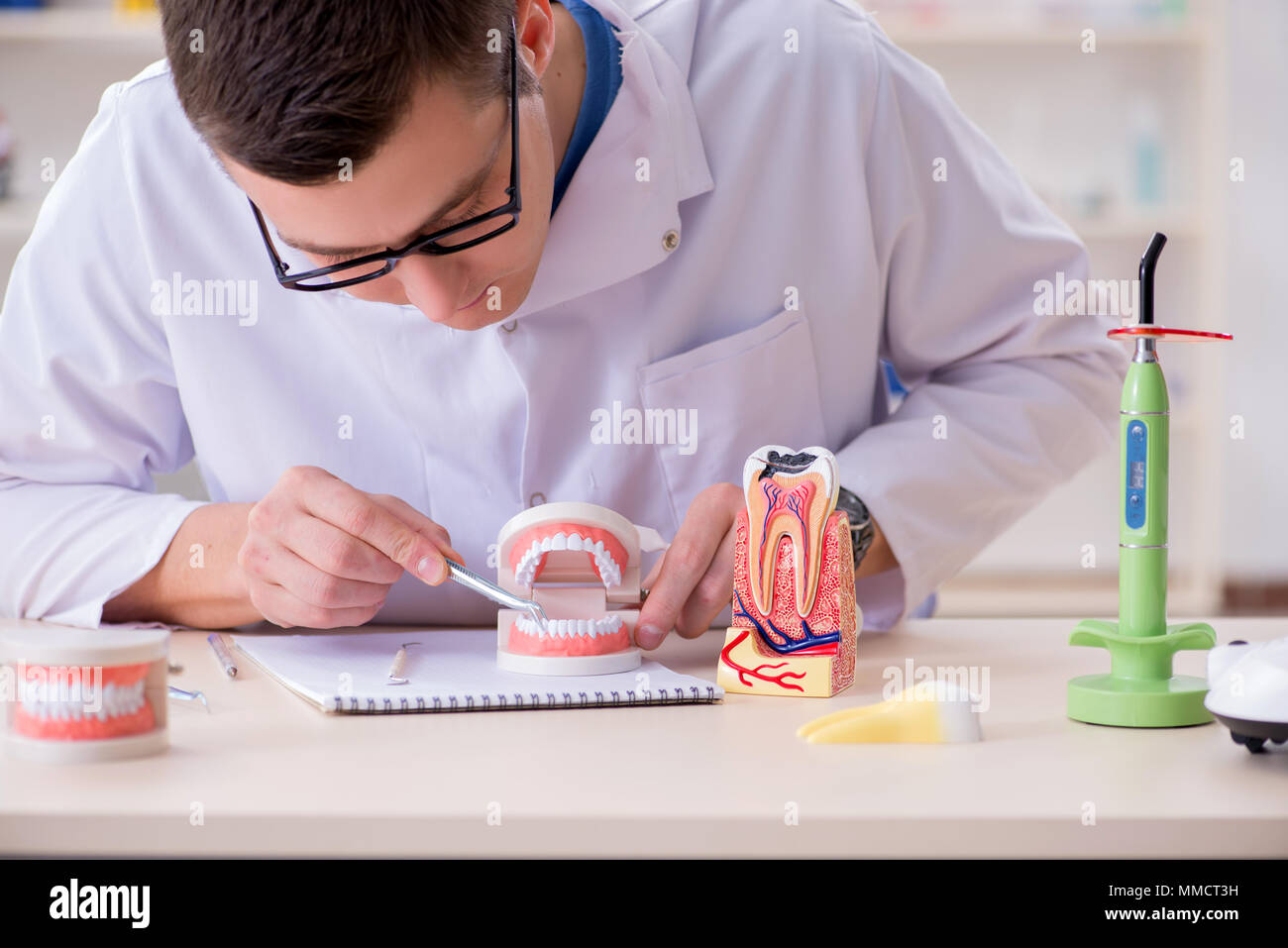 Dentist working teeth implant in medical lab Stock Photo - Alamy