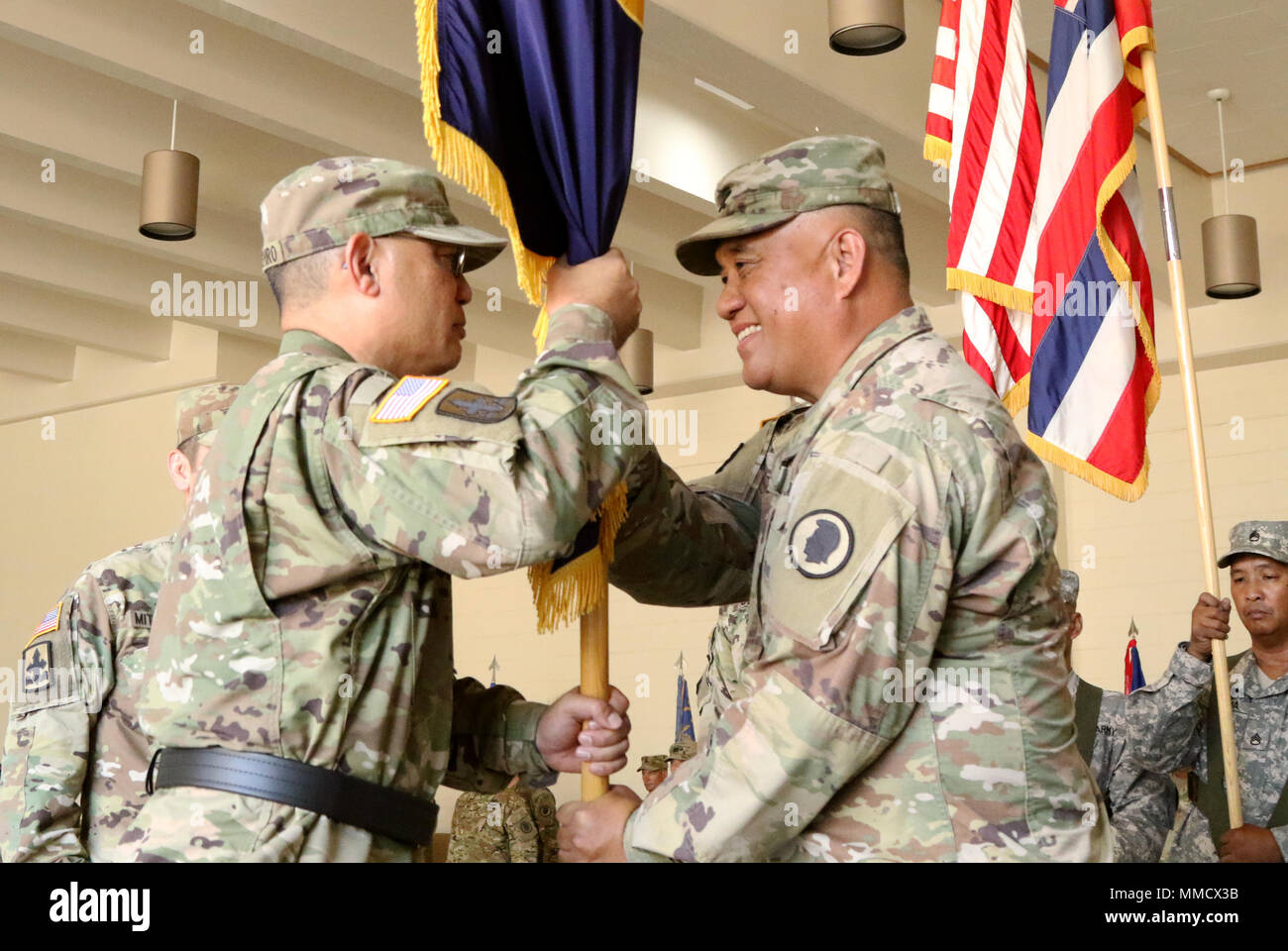 Col. Roger T. Pukahi hands off the 103rd Troop Command guidon to Brig ...
