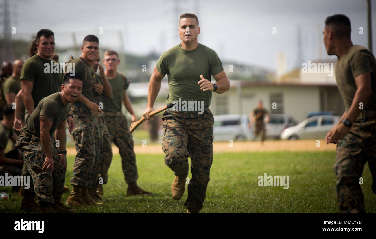 U.S. Marines run through a relay race event during a field meet aboard ...