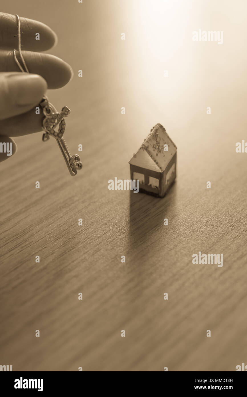 Small house and key in hand Stock Photo - Alamy