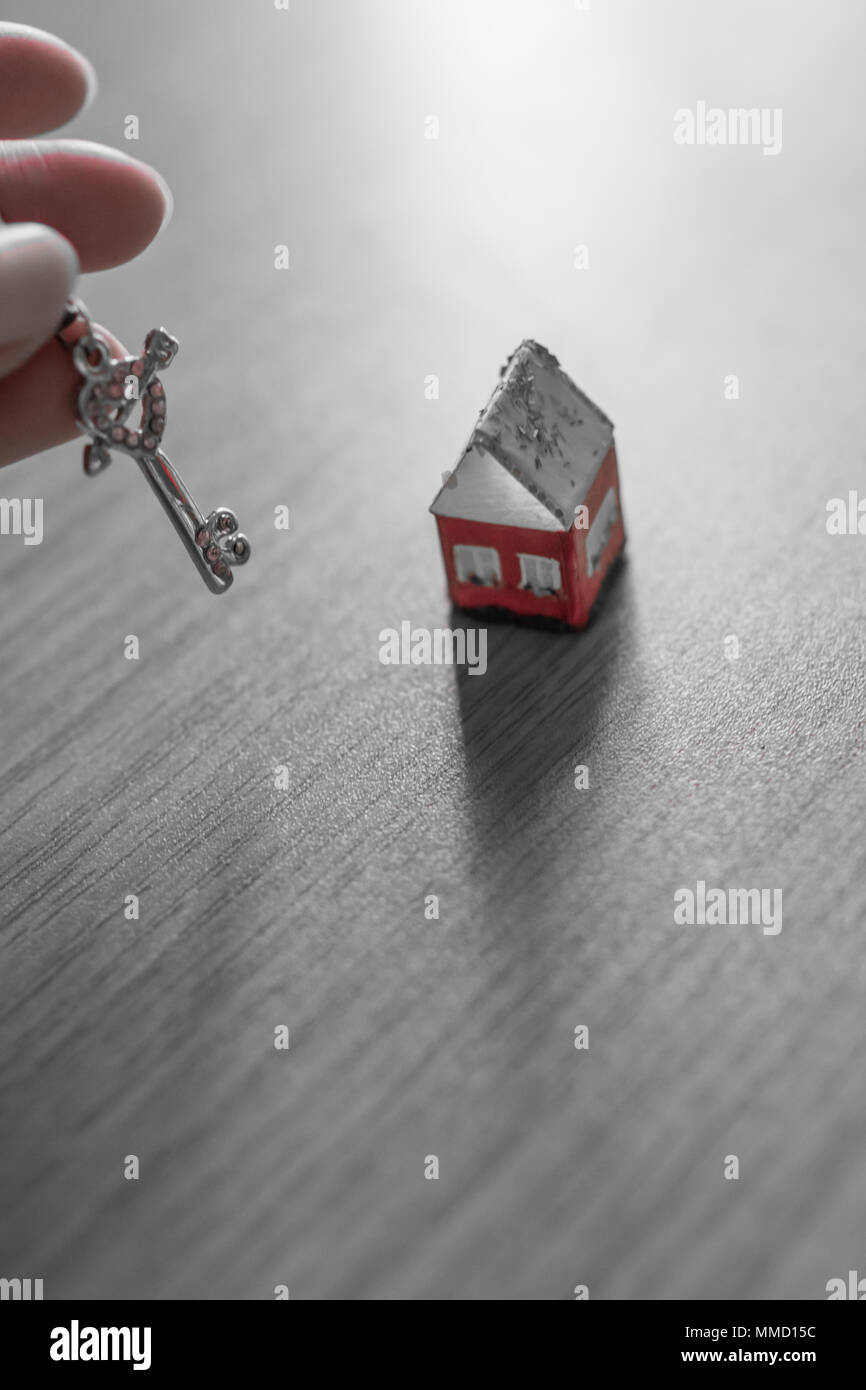 Small house and key in hand Stock Photo - Alamy