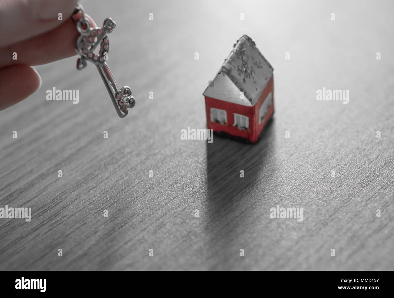 Small house and key in hand Stock Photo - Alamy