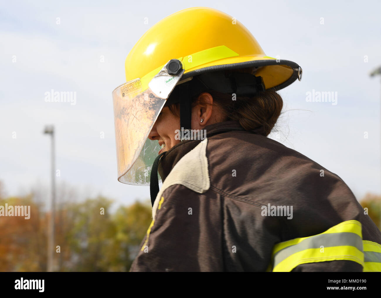 A Grand Forks Air Force Base Airman smiles behind her fire protection ...