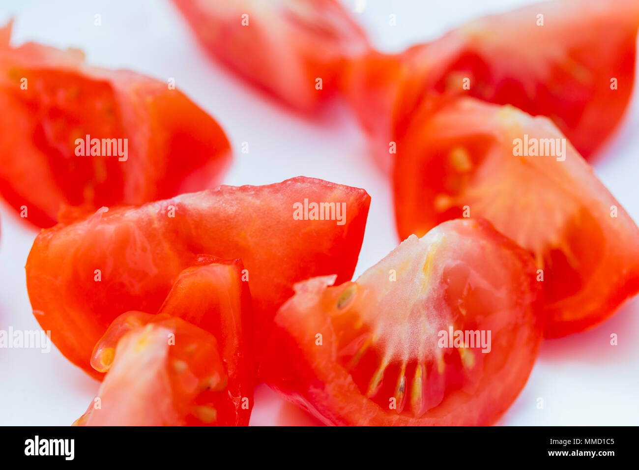 A fresh sliced tomato on white background. Vegetarian salad. Healthy ...