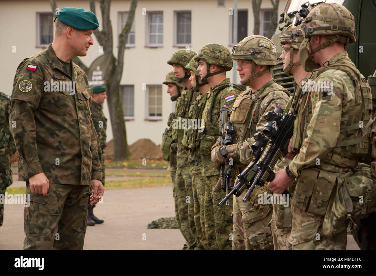 British soldiers assigned to Battle Group Poland speak to a Polish ...