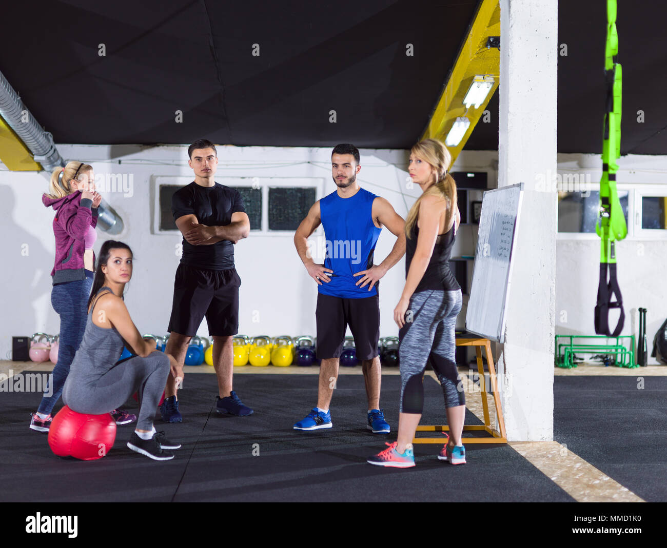 Crossfit training course.group of young athletes getting instructions ...