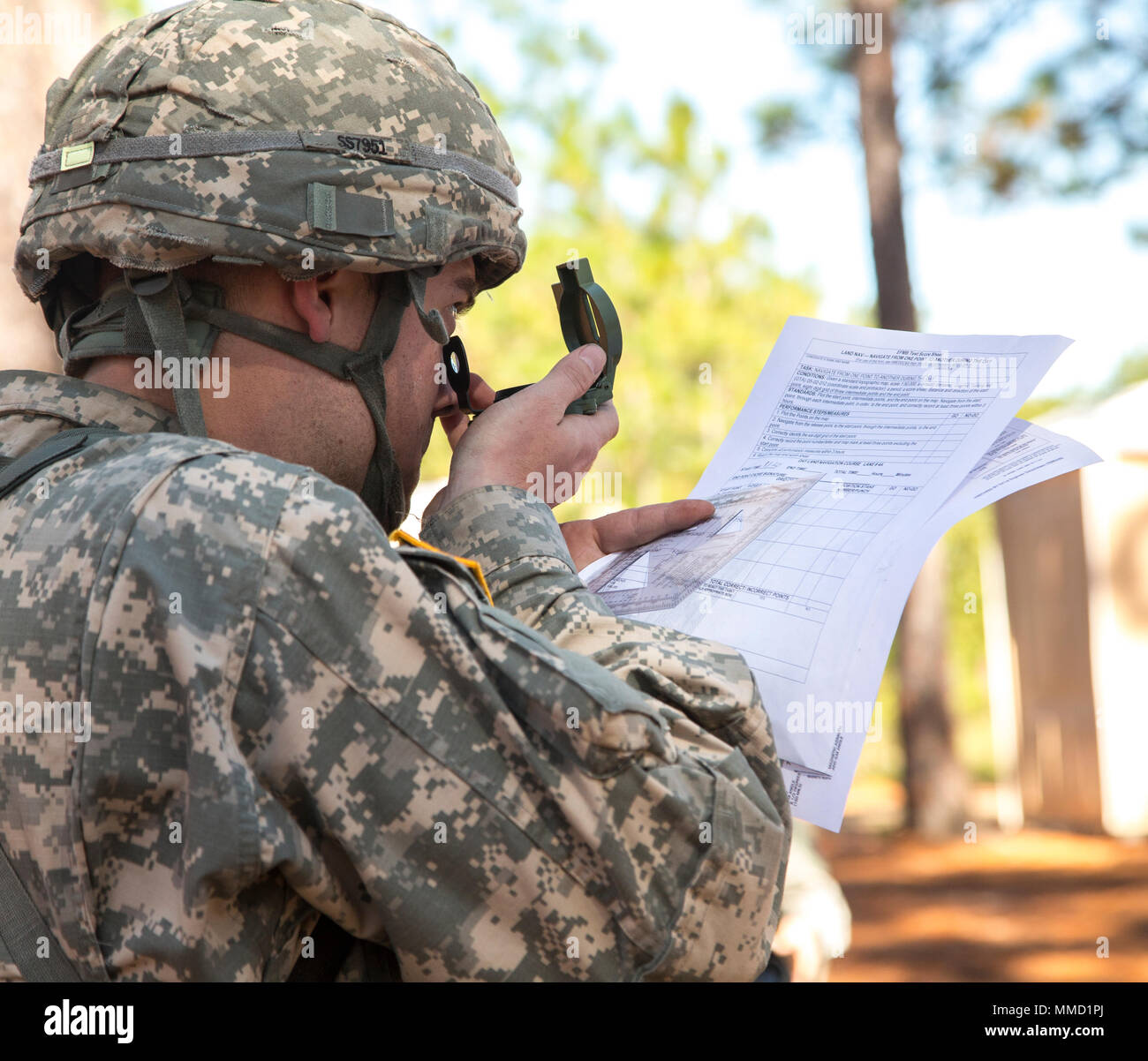 U.S. Army Soldier orients their compass during the land navigation ...