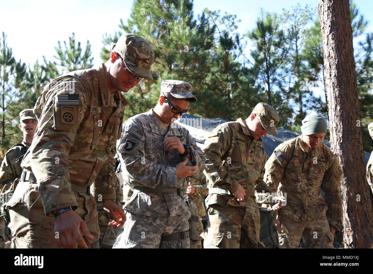 U.S. Army Soldiers, adjust their uniform during the Expert Field ...