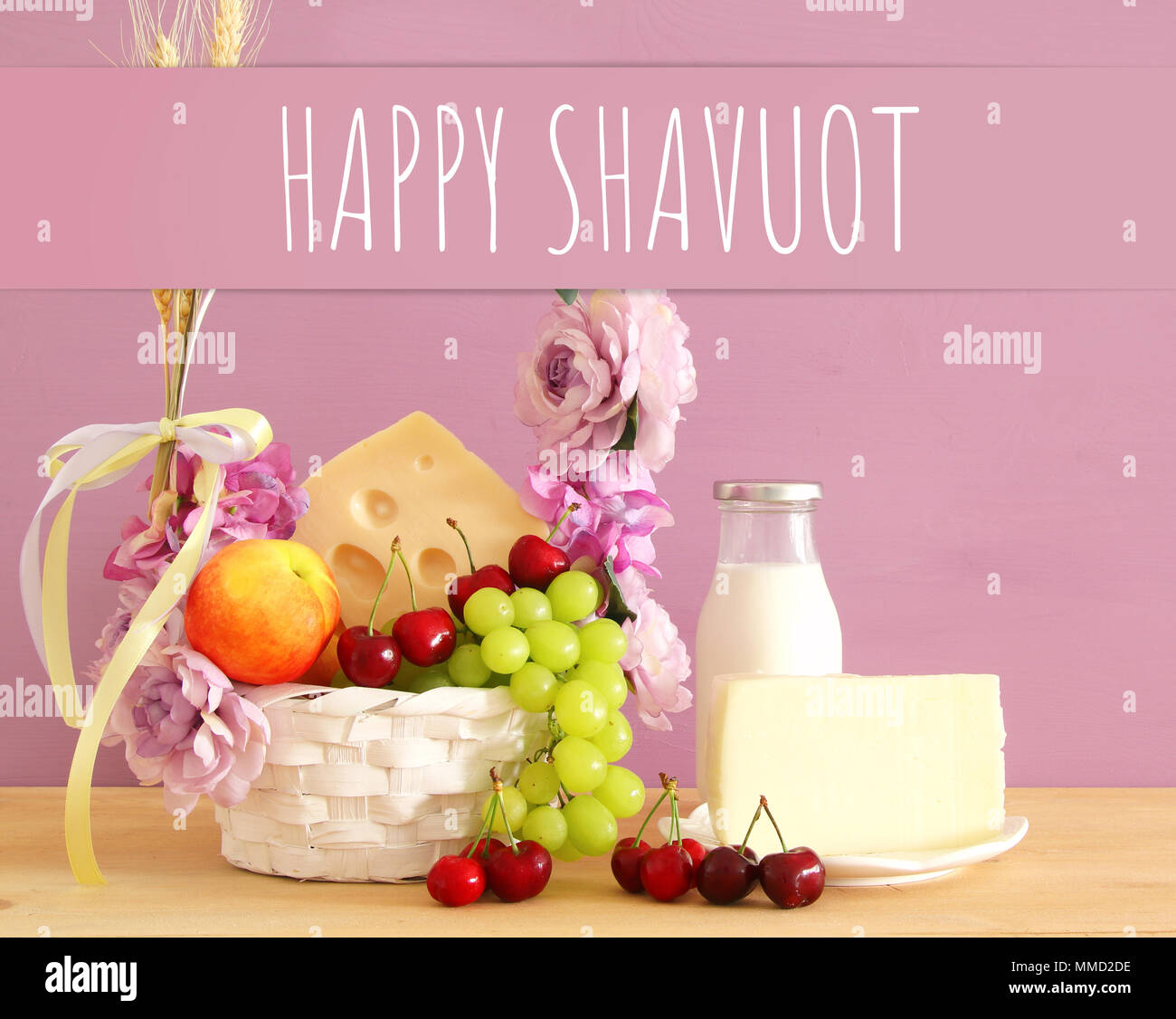 image of fruits and cheese in decorative basket with flowers over ...