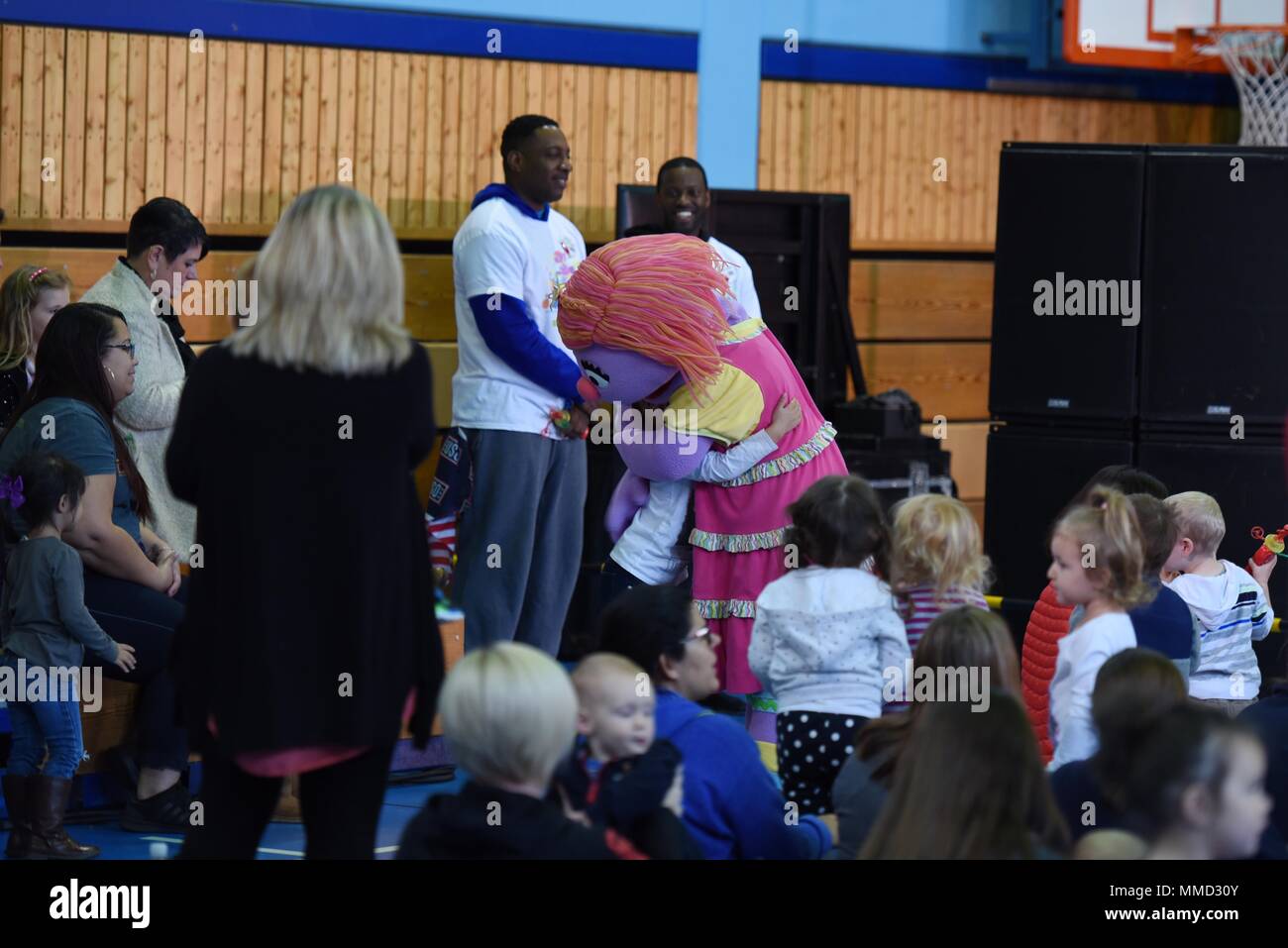 Katie, from Sesame Street, hugs a child in the audience at the USO’s ...