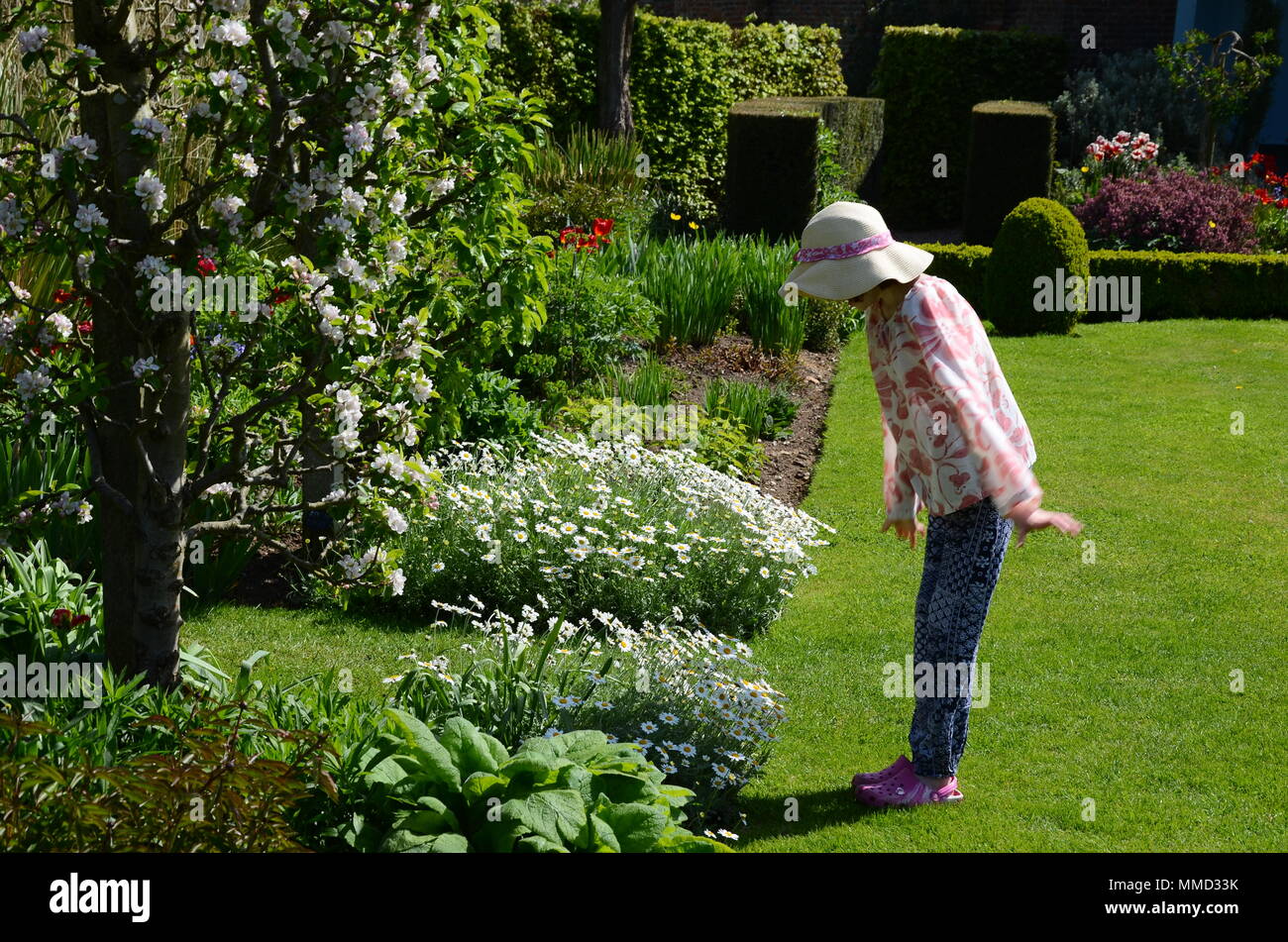 Visitors touring the gardens at Gunby Hall in Spring, Lincolnshire, UK ...