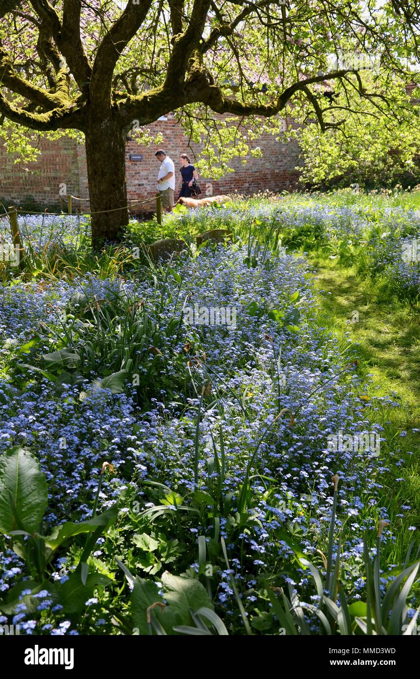 Visitors touring the gardens at Gunby Hall in Spring, Lincolnshire, UK ...