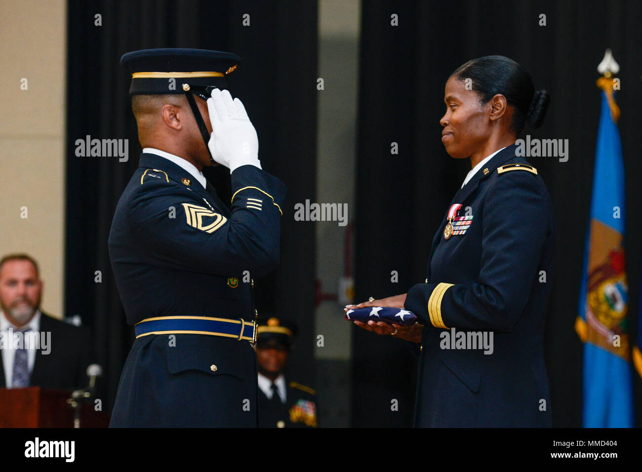 U.S. Army Brig. Gen. Barbara Owens receives the American flag and a ...