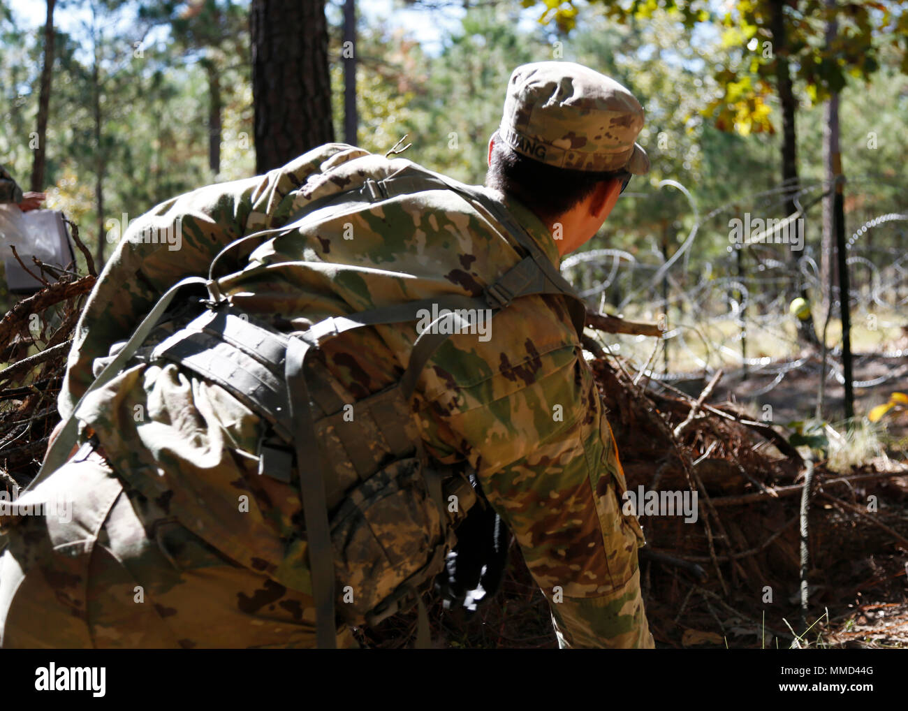 U.S. Army Candidates participate in an obstacle course during the ...