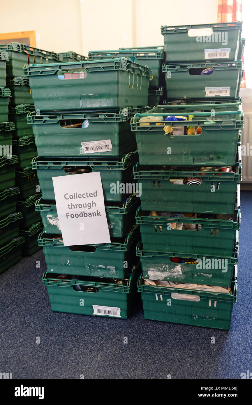 Boxes of food piled up in a food bank for distribution to people in ...