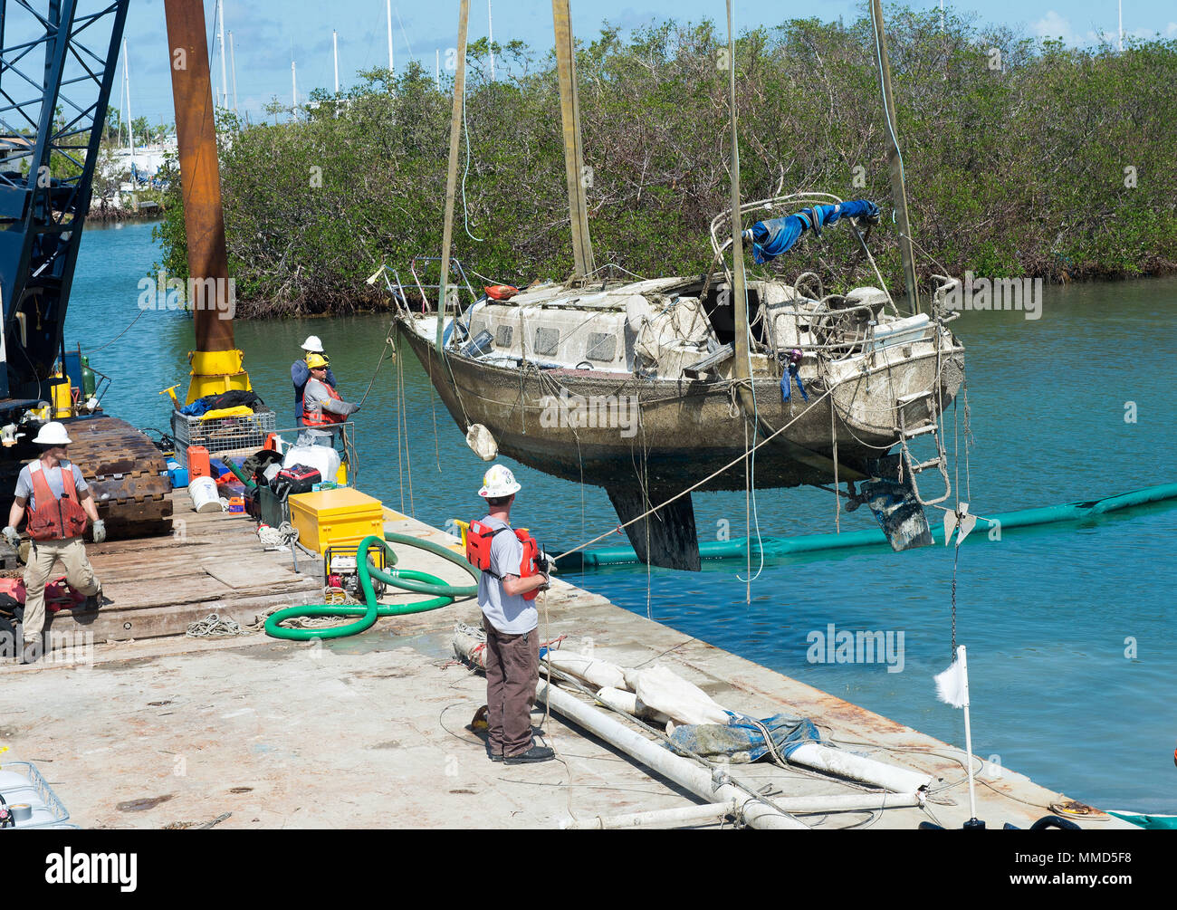 Response crews work to remove a submerged vessel in Boot Key Harbor ...