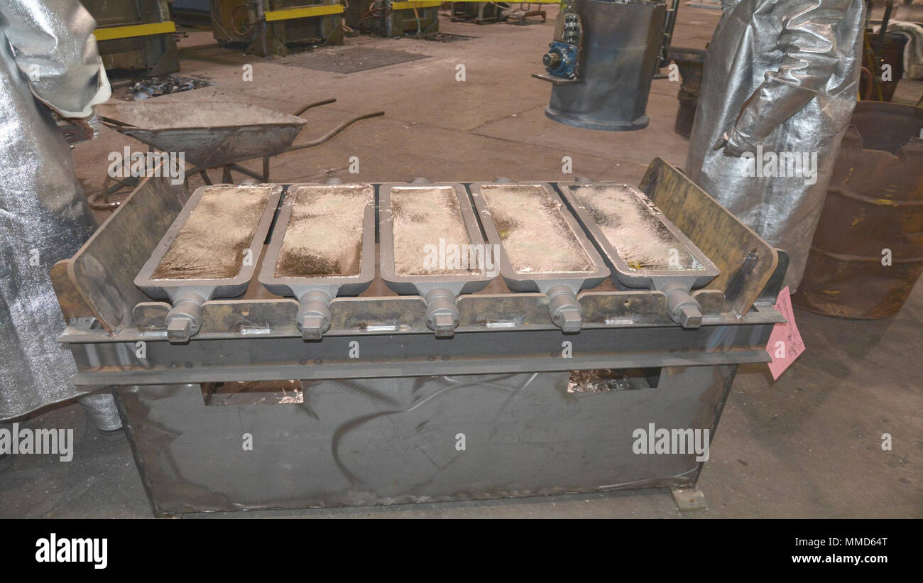 Re-melted tin affected with tin pest is poured into ingot molds at Rock ...