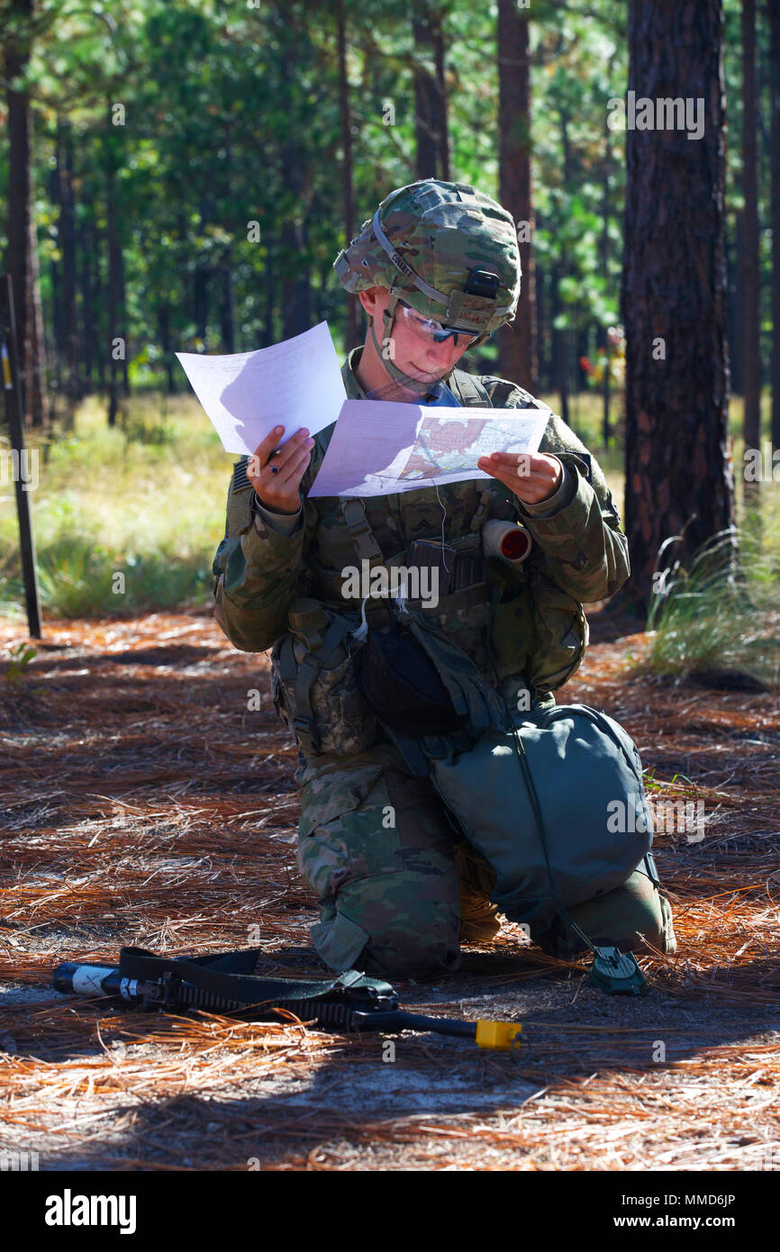 U.S. Army soldier studie her map on a land navigation test during the ...