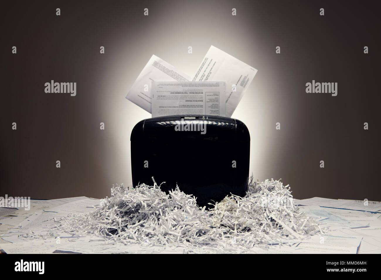 Office shredder and personal documents being shredded, with piles of ...