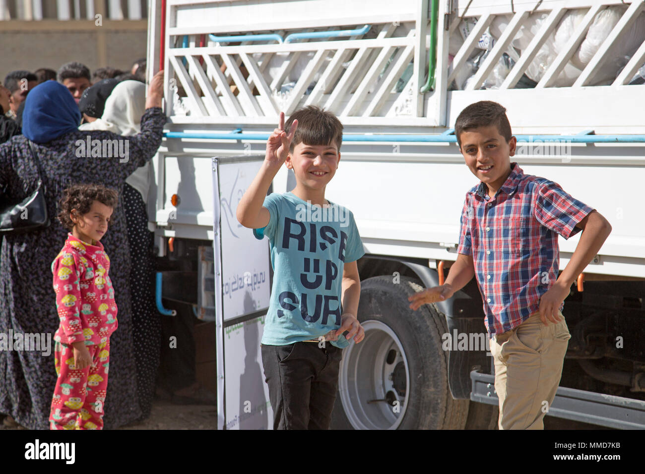 Two young Kurdish boys pose for a photo in a make-shift internally ...