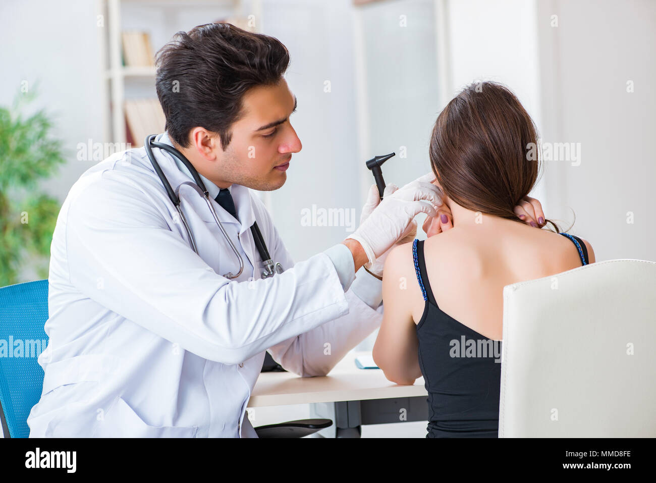 Doctor checking patients ear during medical examination Stock Photo - Alamy