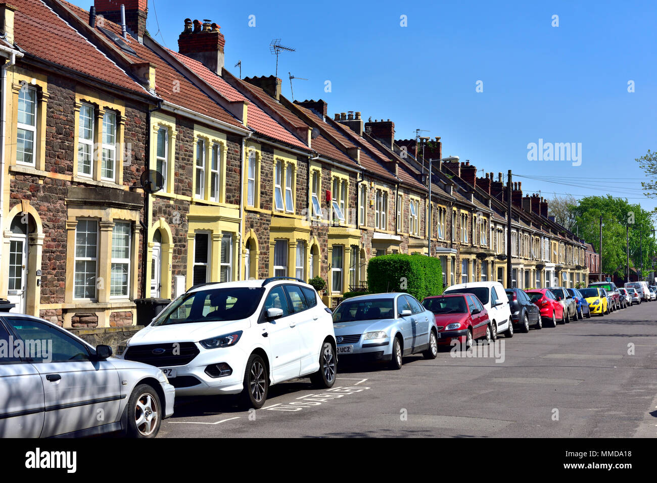 Row of stone period two storey Edwardian terrace houses along street in ...